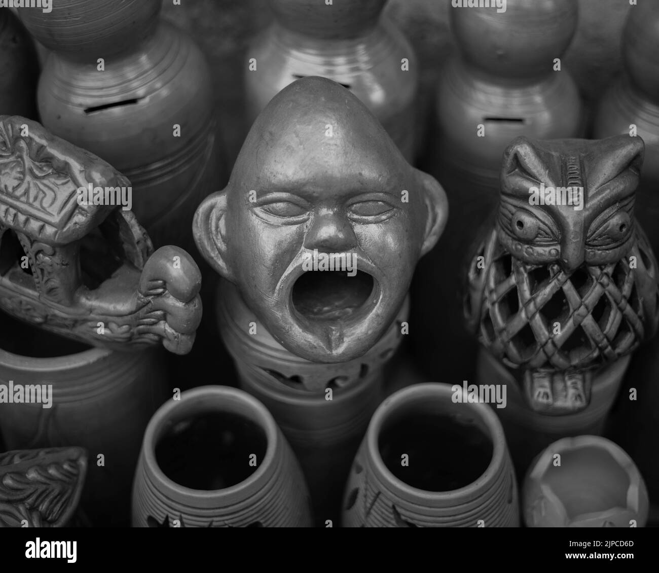 A closeup of various vases made with clay shot in grayscale Stock Photo ...