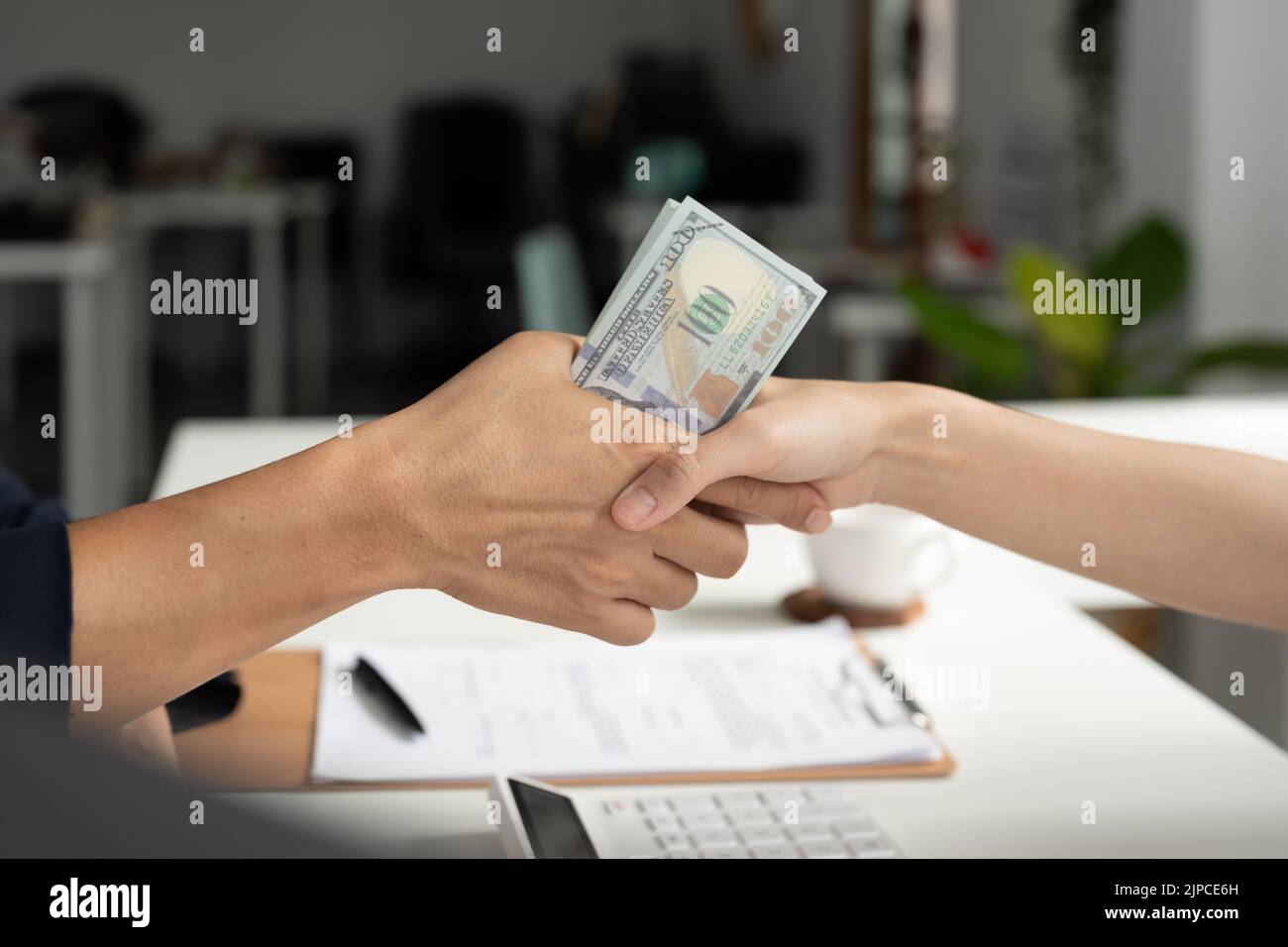 Businessmen making handshake with money in hands - bribery, corruption ...