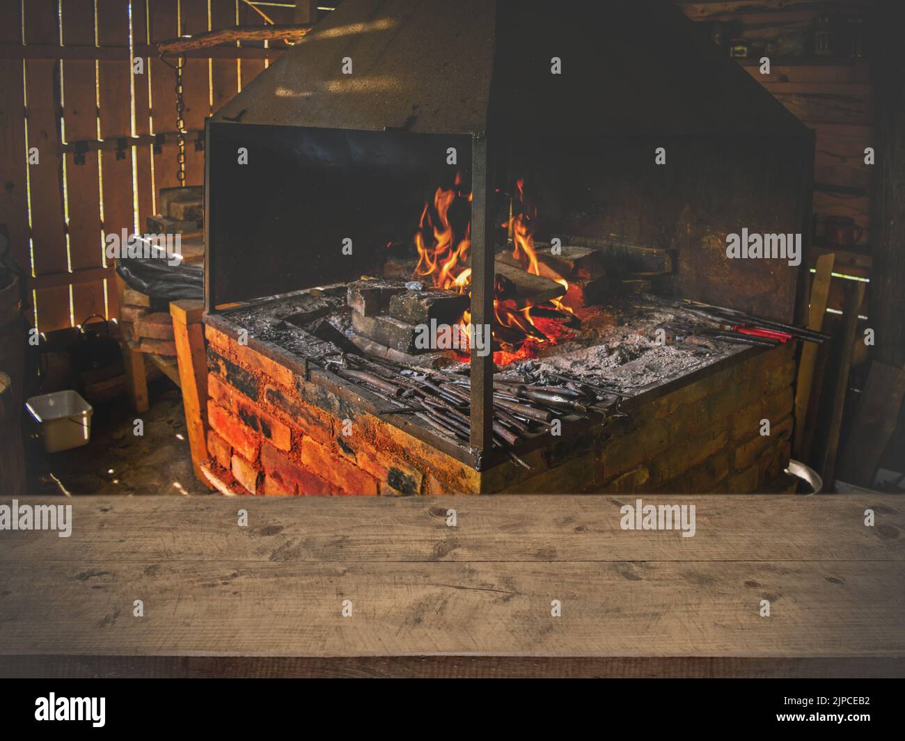 Interior of an old forge. Bright fire burning in the furnace. Forge ...