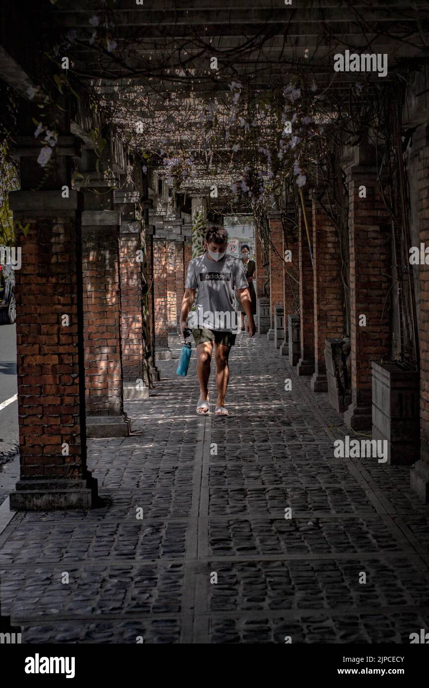 A beautiful shot of a Filipino boy walking in the streets of the ...