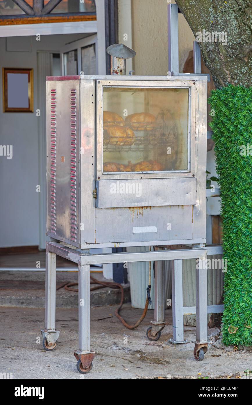 Commercial Chicken Rotisserie Roasting Machine in Front of Restaurant ...