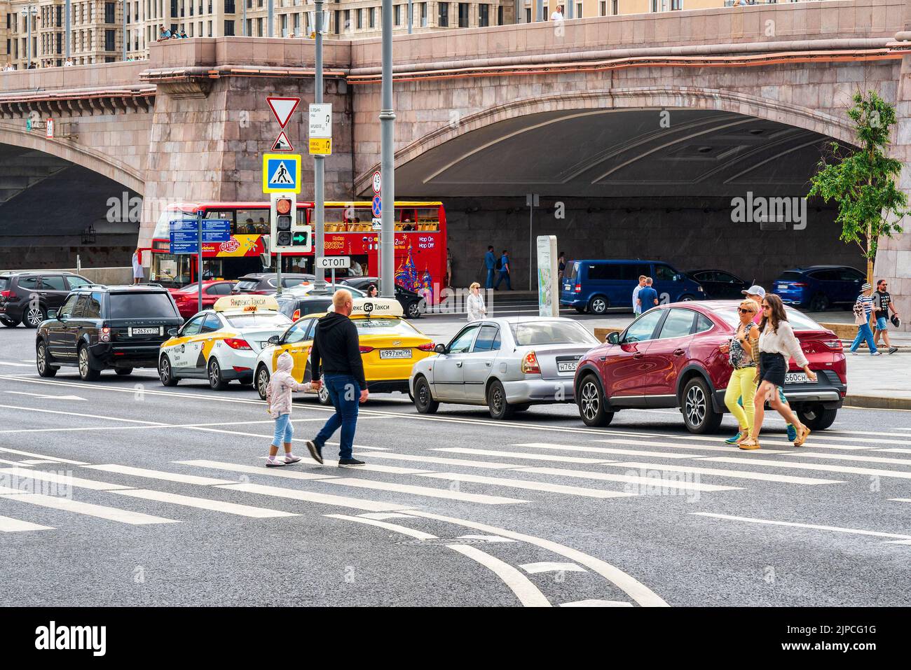 MOSCOW, RUSSIA, 17 JULY, 2022 : People crossing the asphalt road at the ...