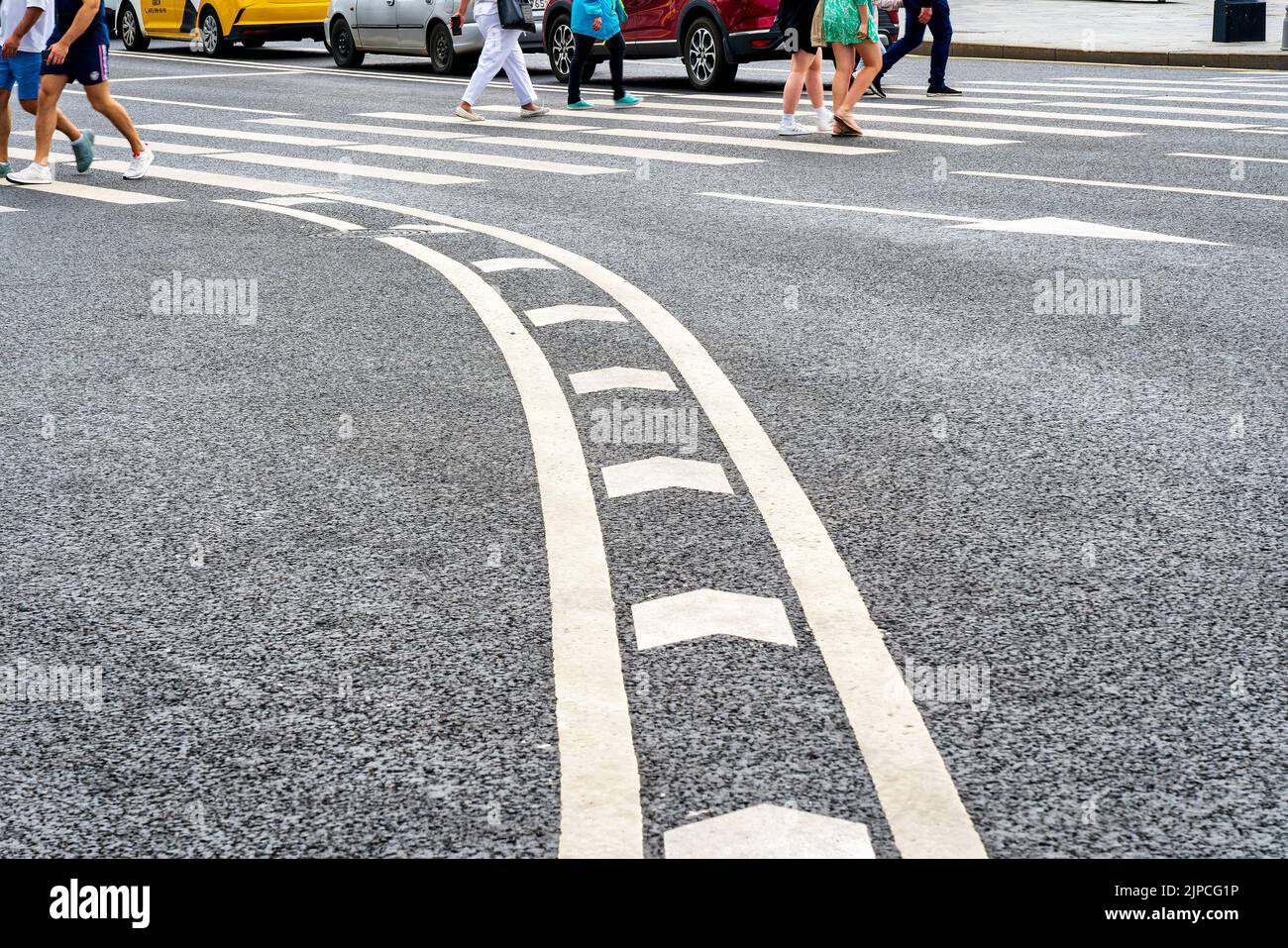 MOSCOW, RUSSIA, 17 JULY, 2022 : People crossing the asphalt road at the ...