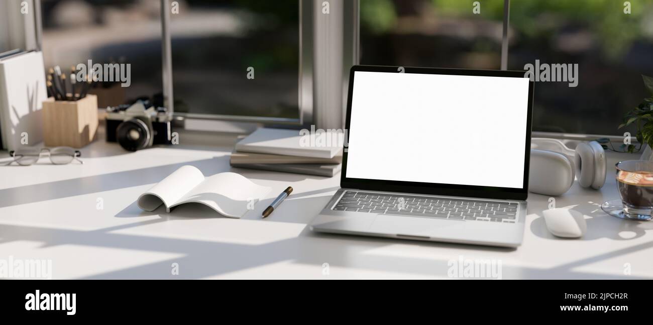 A Modern Office Workspace Tabletop Against The Window With Notebook