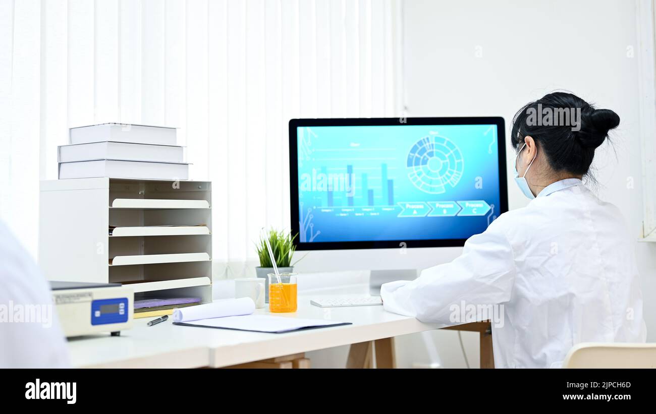 A millennial Asian female chemist or scientist working on her ...