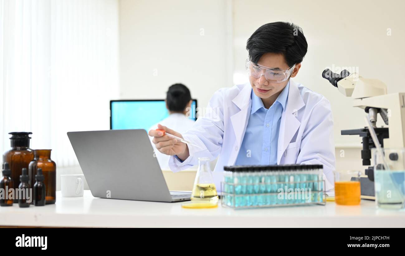 Pharmaceutical research researcher adjusting hi-res stock photography ...