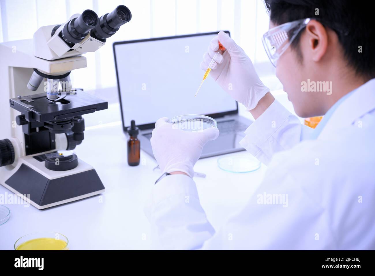 Professional Asian male scientist or medical researcher in goggles ...