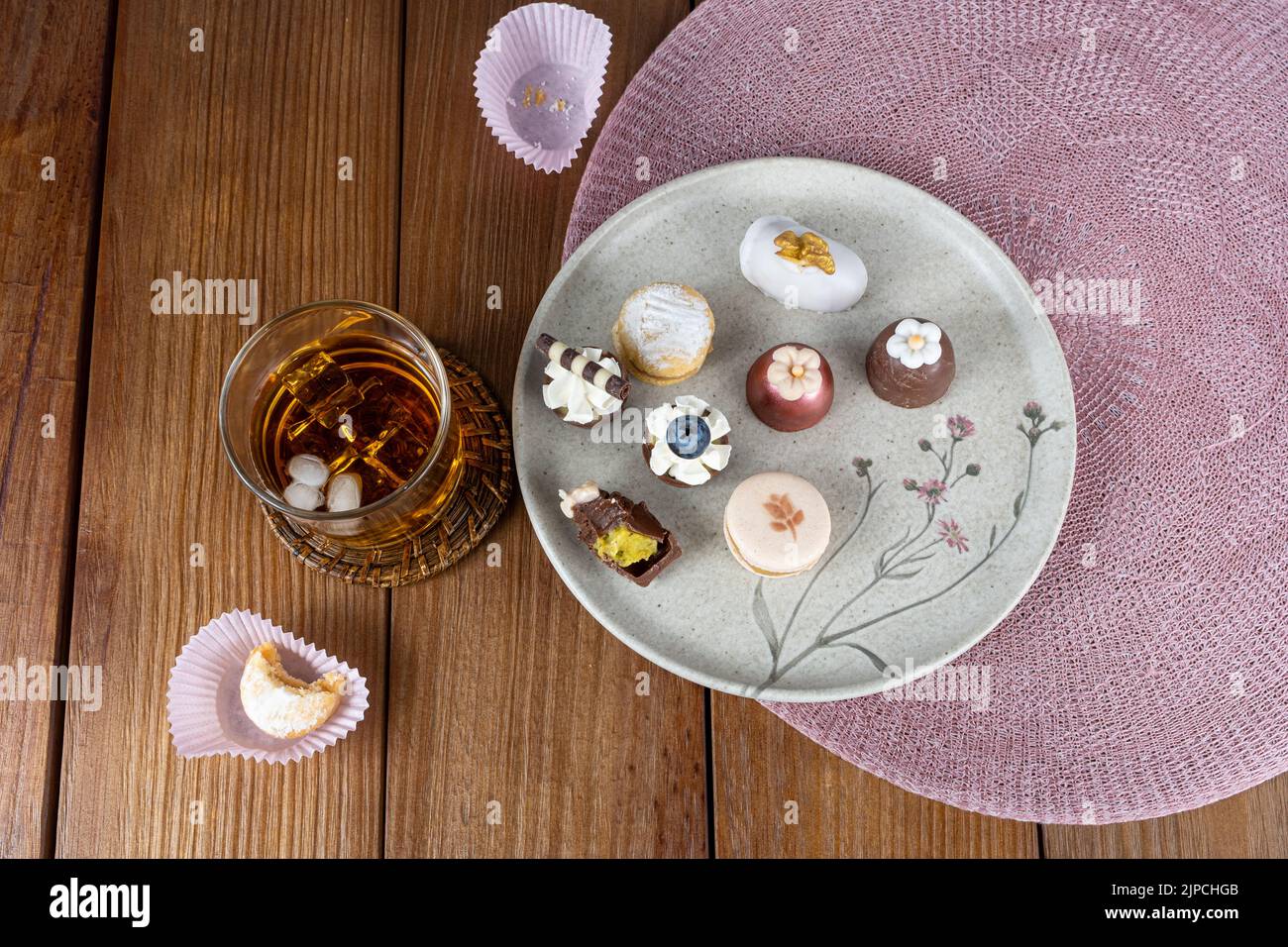 Small chocolate glass with whipped cream and blueberry frosting next to ...