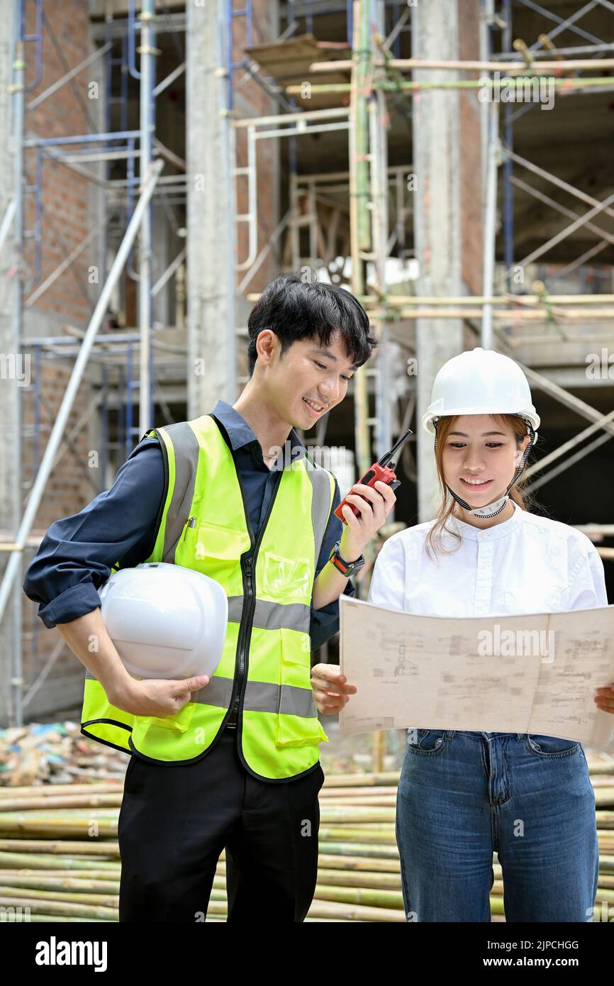 Smart and handsome young asian male engineer and beautiful female ...