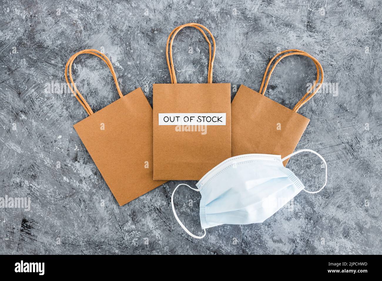 Out of Stock text on top of shopping bag with surgical mask, concept of ...