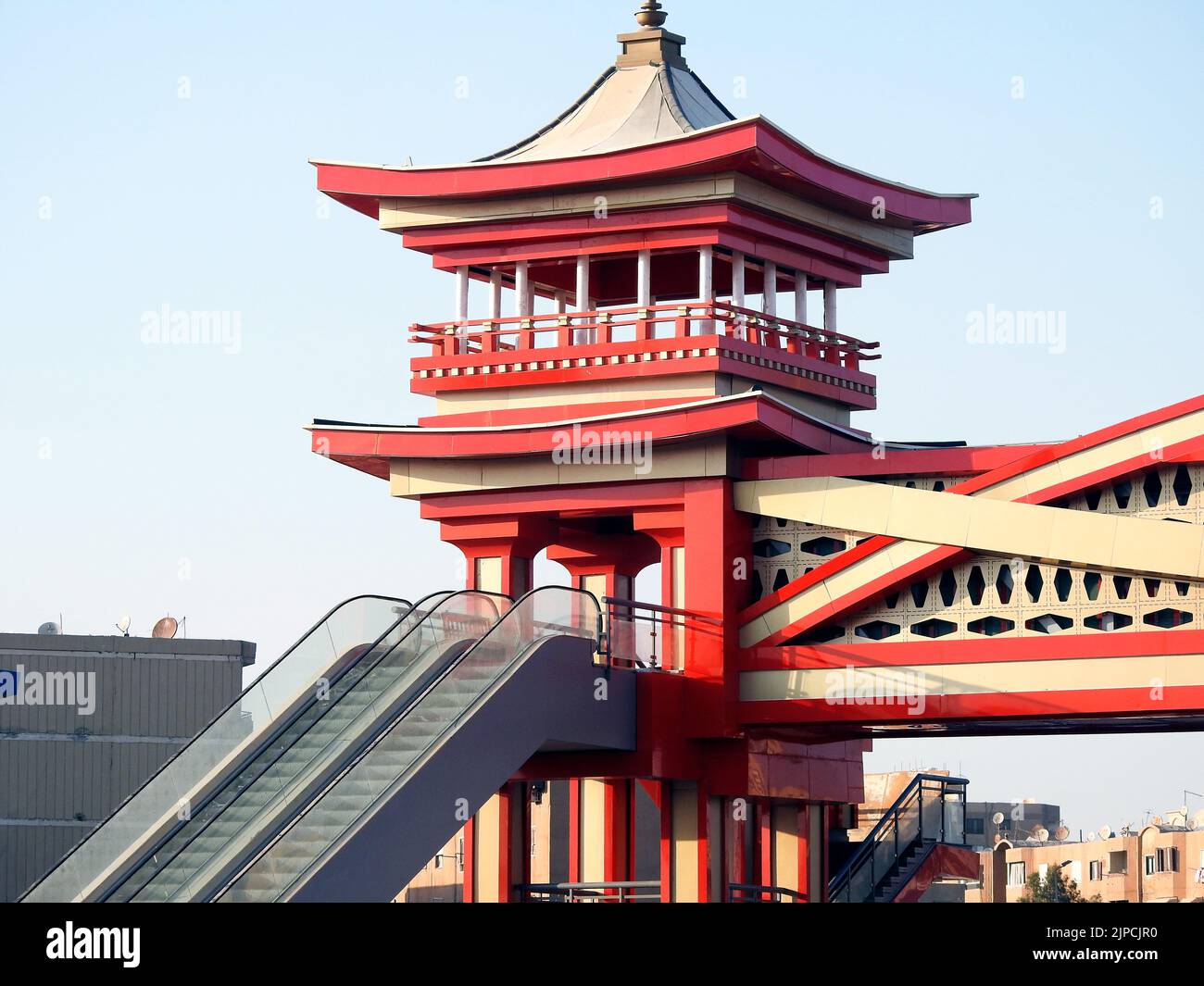 A pedestrian bridge finished in traditional Japanese architectural style, the bridge is served ...