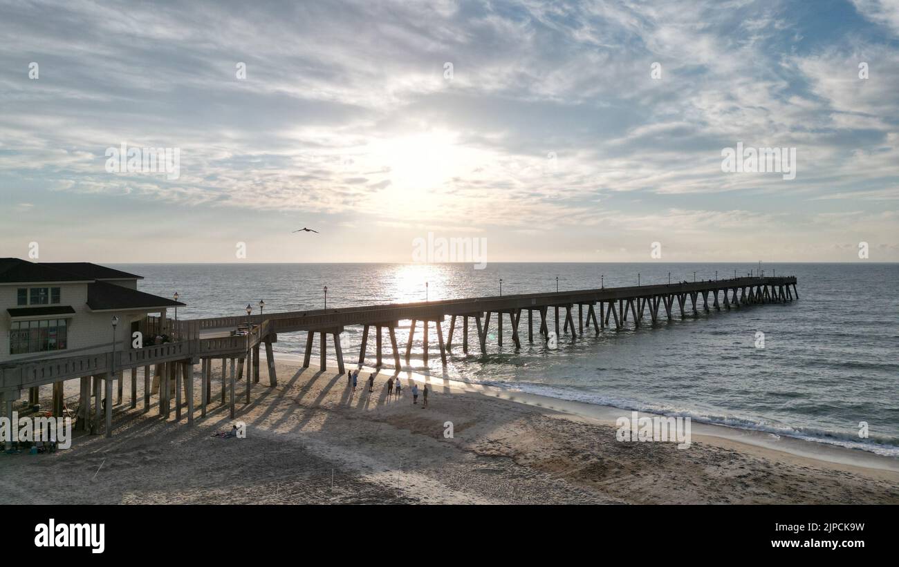 The sun rising over the beach Stock Photo - Alamy