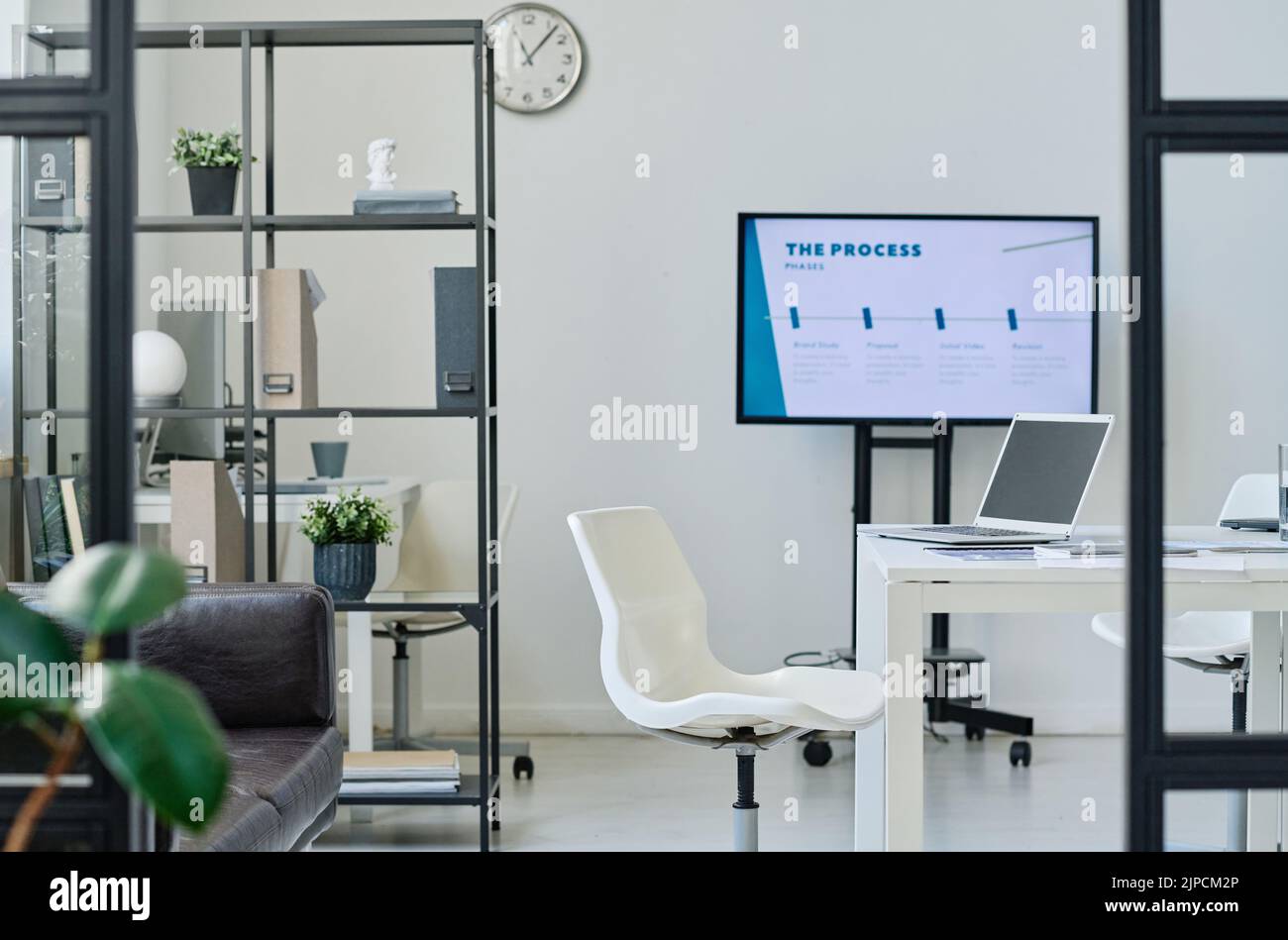 Modern office room with table in the middle and big monitor for meeting ...
