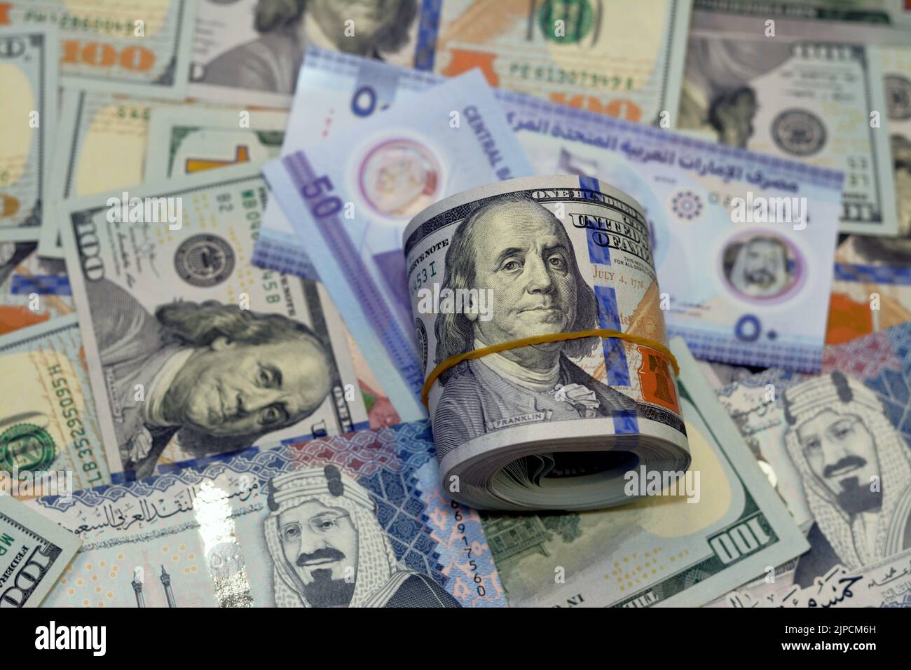 American money roll with a band on a pile of American dollar bills ...