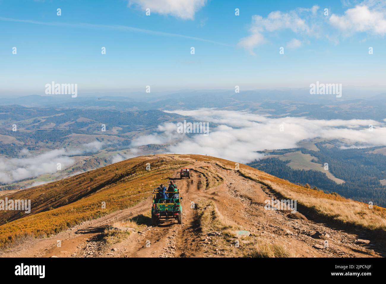 people riding suv cars at the mountain peak Stock Photo - Alamy