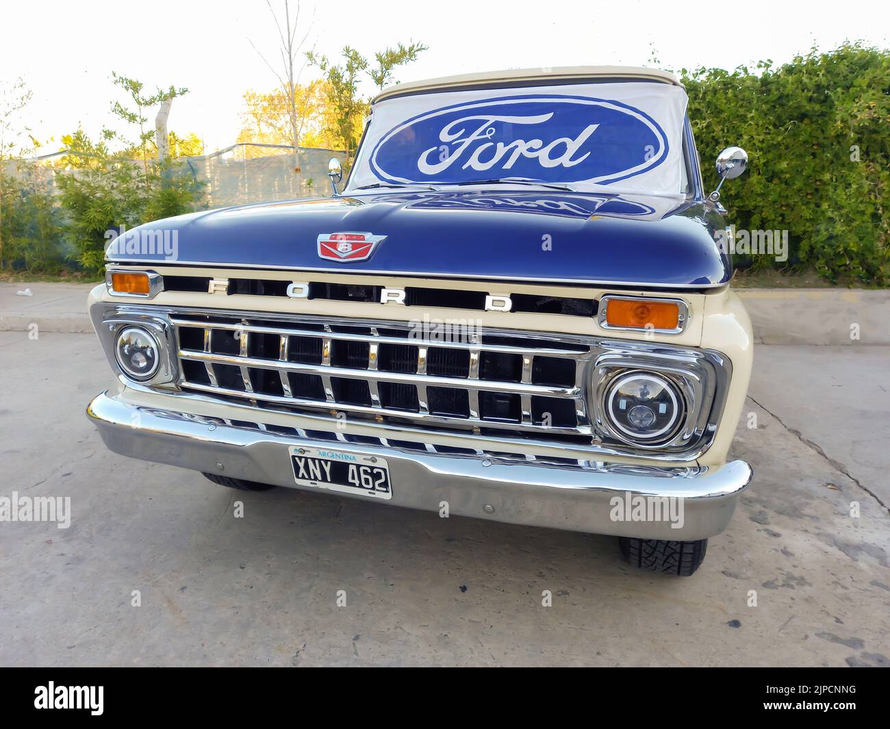 Ford blue oval logo and brand on the windshield of an old F100 V8 ...