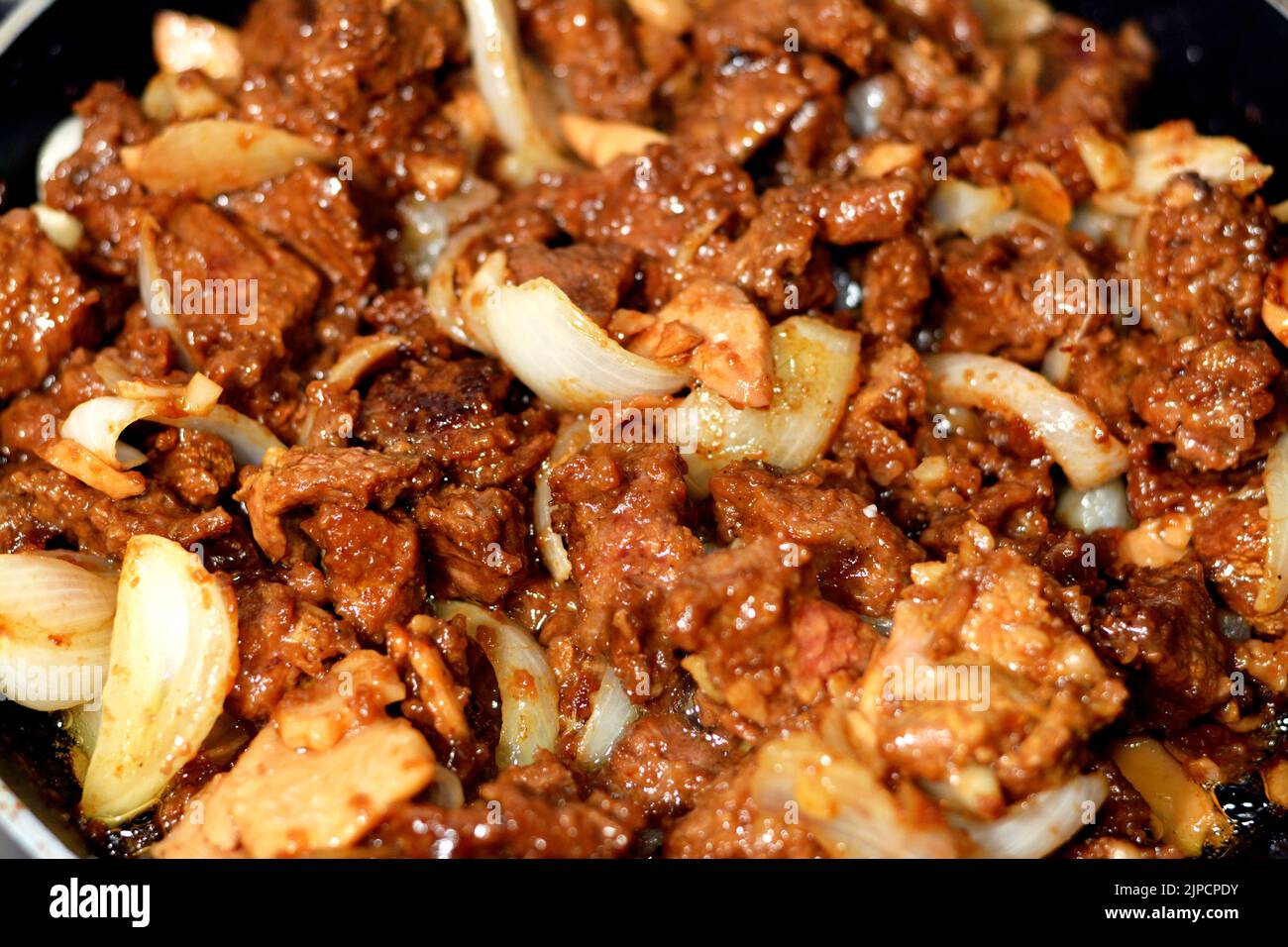 Selective focus of pieces and cubes of beef red meat grilled with oil ...