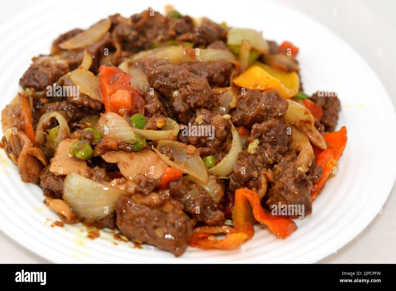 A plate of Chinese food cuisine of grilled beef red meat pieces with ...