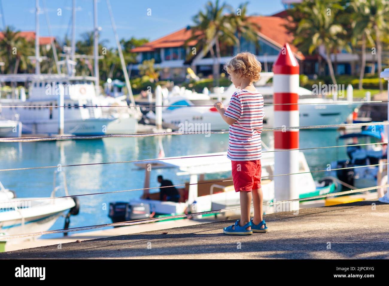 Child watching yacht and boat in harbor. Yachting sport for family with ...