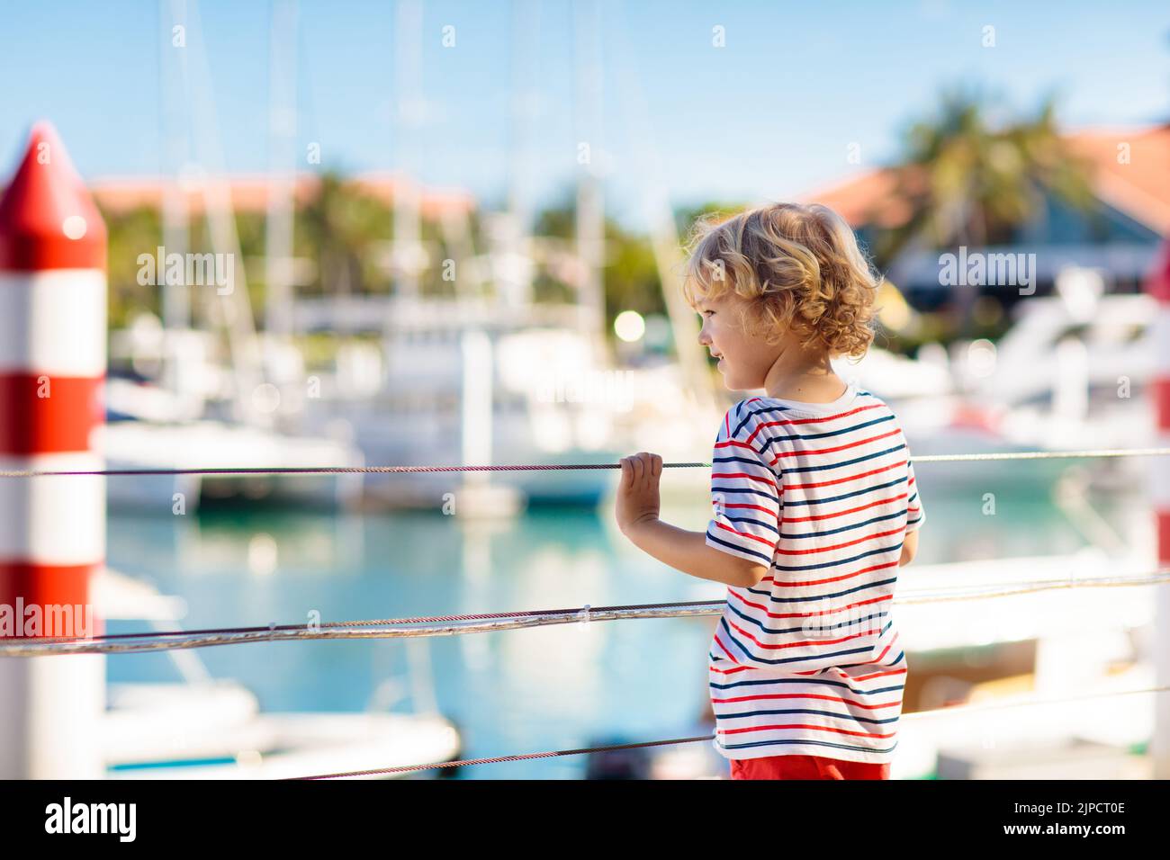 Child watching yacht and boat in harbor. Yachting sport for family with ...