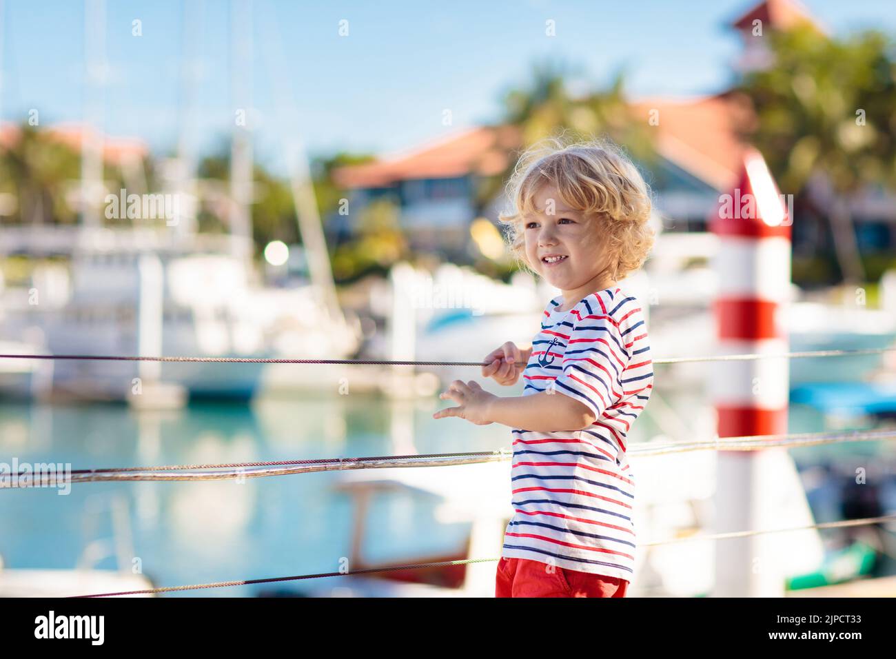 Child watching yacht and boat in harbor. Yachting sport for family with ...