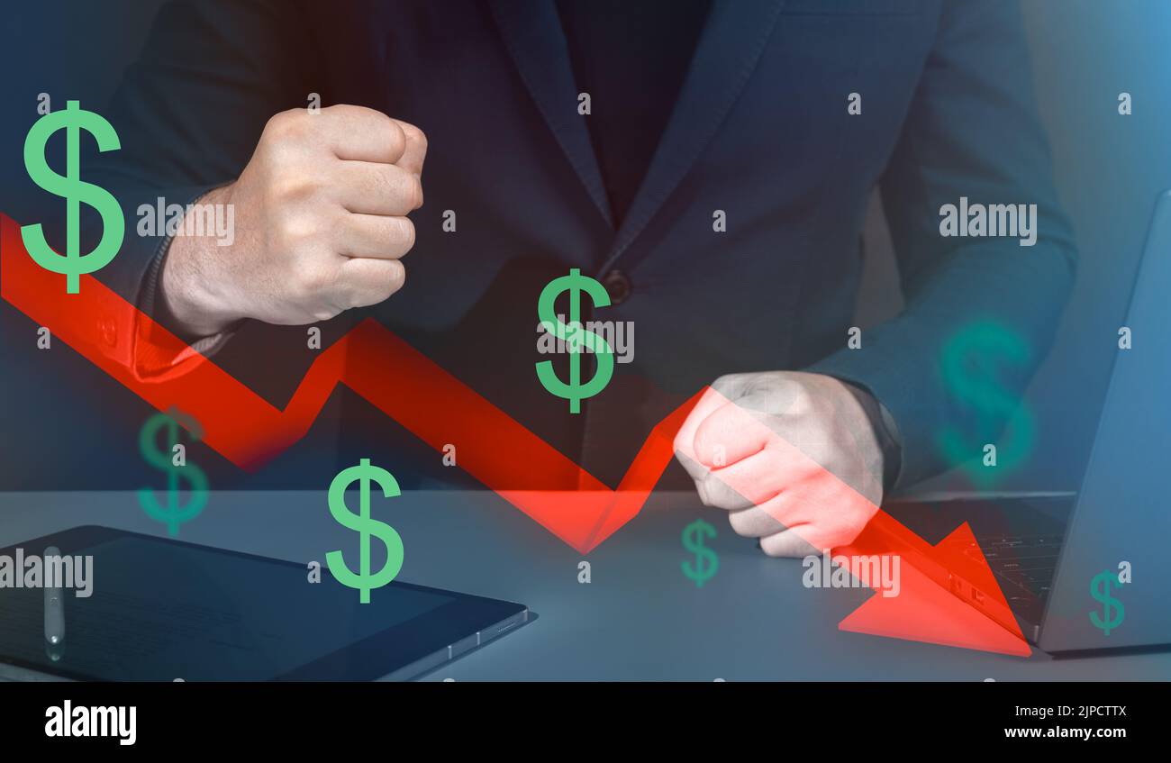 furious businessman clenching his fists looking at graph of declining ...