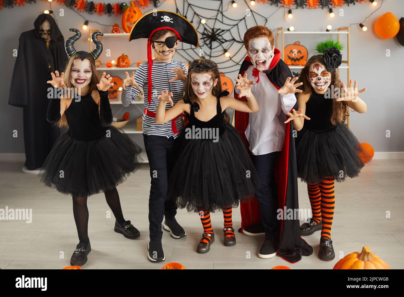 Portrait of group of children in creative costumes with scared faces at ...