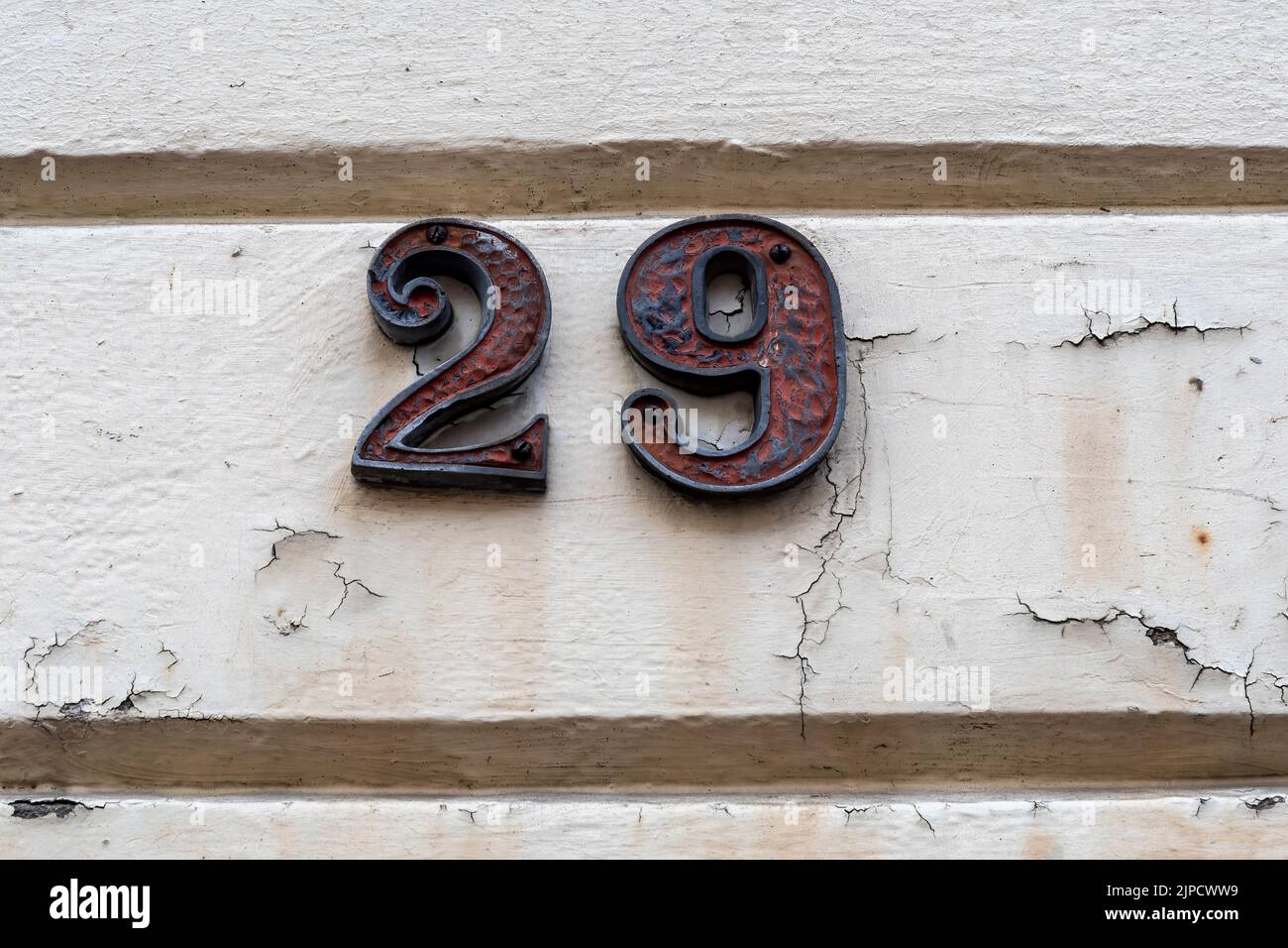 Number twenty nine on peeling wall by doorway Stock Photo - Alamy