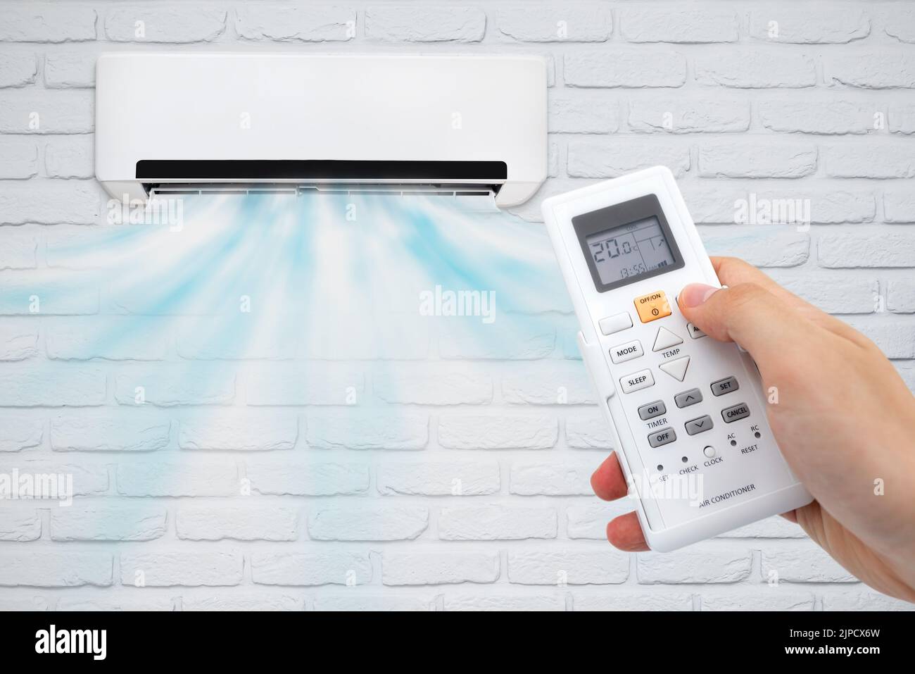Air conditioning and a stream of fresh cold air. Hand holding remote ...