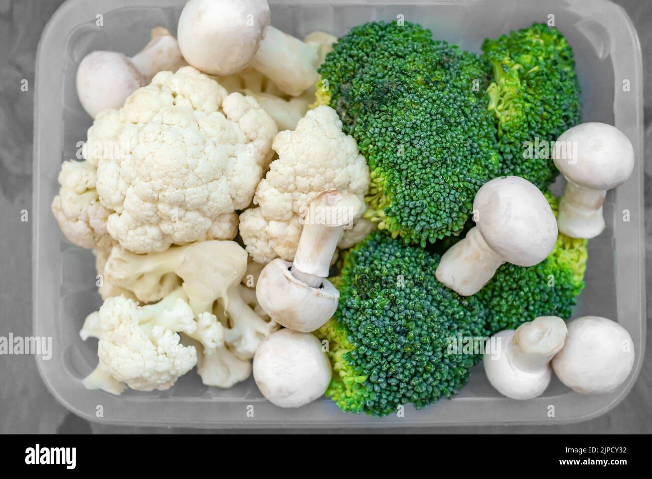 lots of broccoli and cauliflower and mushrooms on the table in a ...