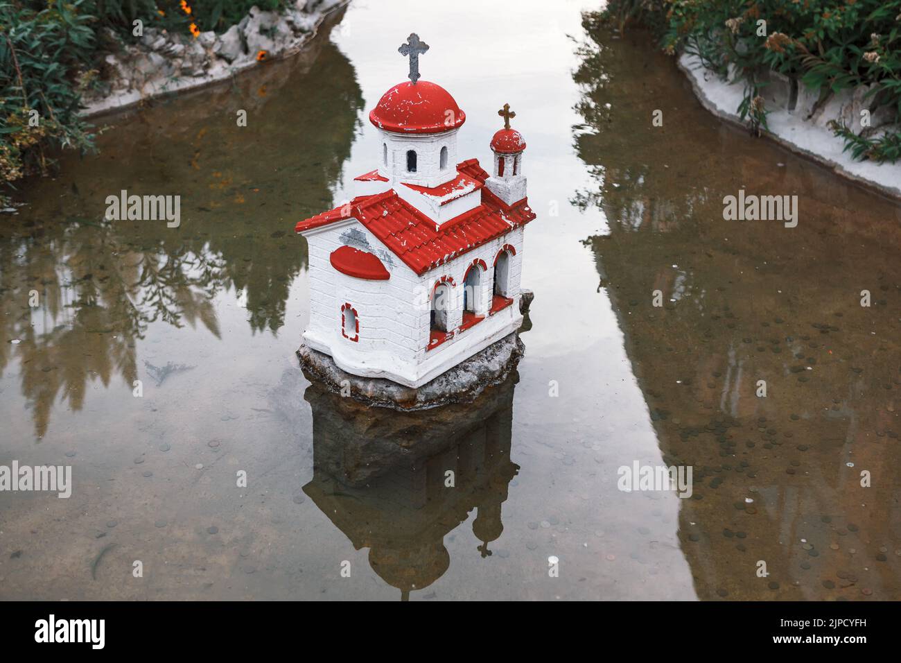 Church on the water . Miniature place of worship . Fountain water with ...