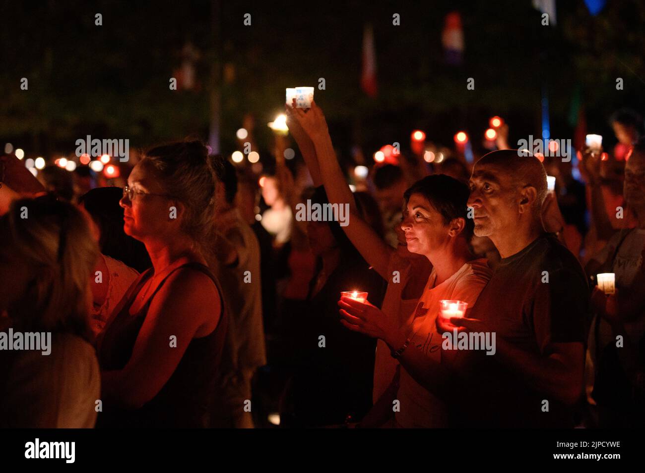 People with candles praying and singing during the veneration of the ...