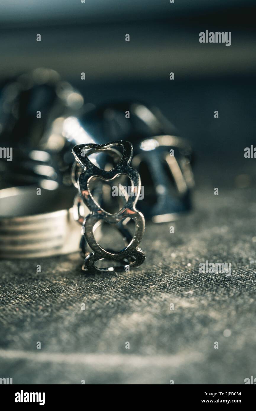A vertical closeup shot of a silver heart patterned ring Stock Photo - Alamy