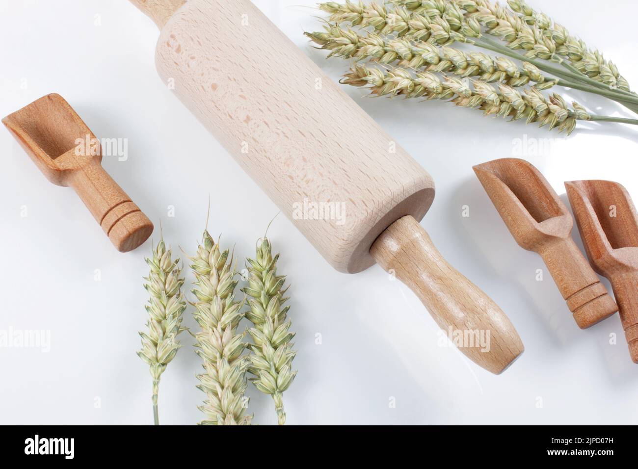 Rolling pin with wheat and spoons isolated on white background. Organic ...