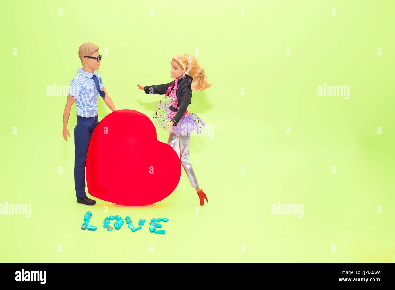 Lovely young toy couple and big love heart and green love Stock Photo ...
