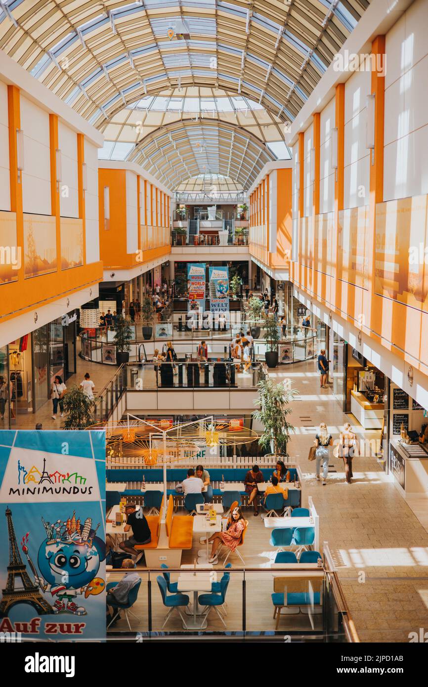 A vertical shot of an interior of a crowded shopping center in ...
