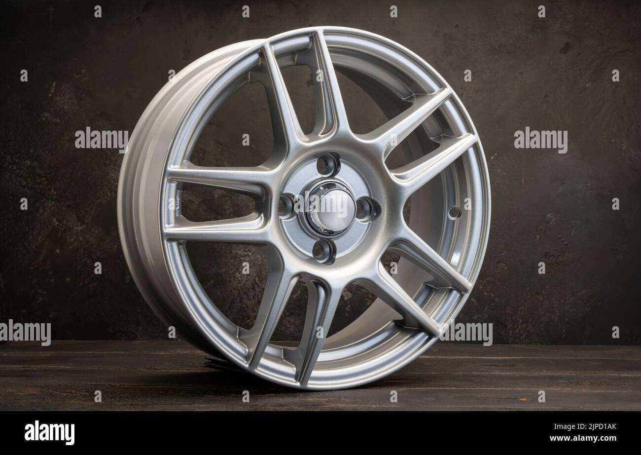 new grey alloy wheels on a dark textured black background. a wheel for ...