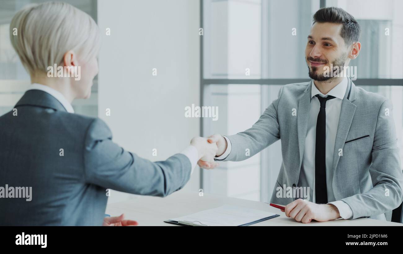 HR male manager shaking hand to female candidate after having job ...