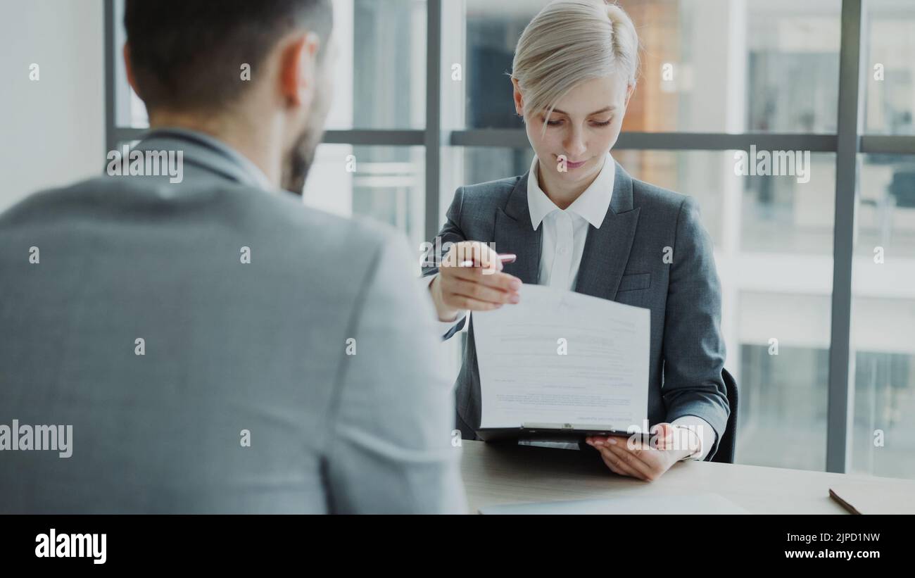HR businesswoman having job interview with young man in suit and ...