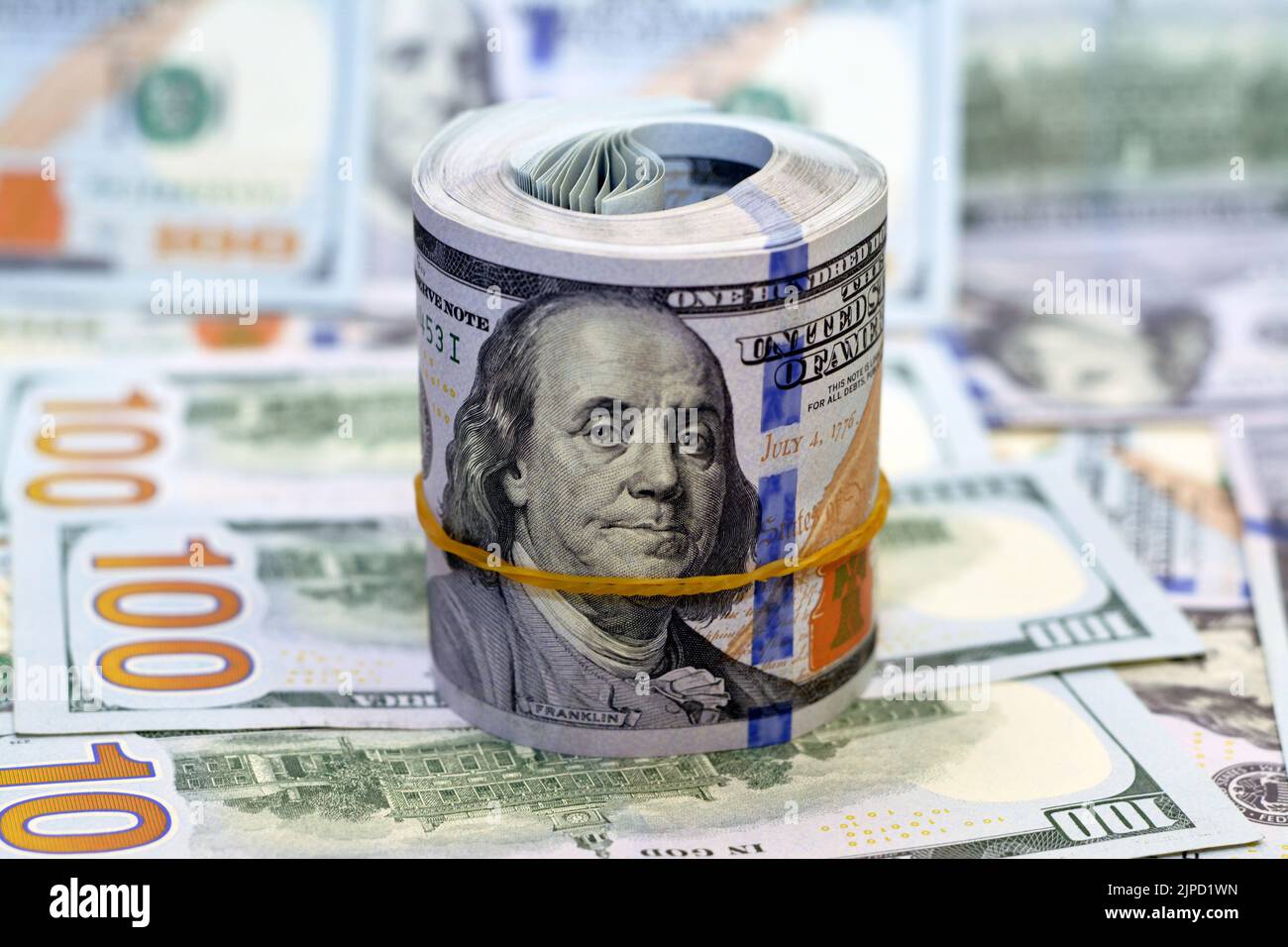 Bundle of money roll of dollars on a pile of 100 $ banknotes, stack of ...