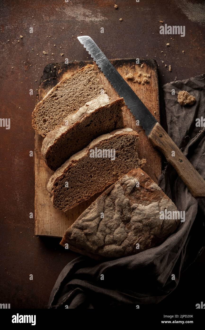Low key food photography. Black rustic bread on dark background Stock ...