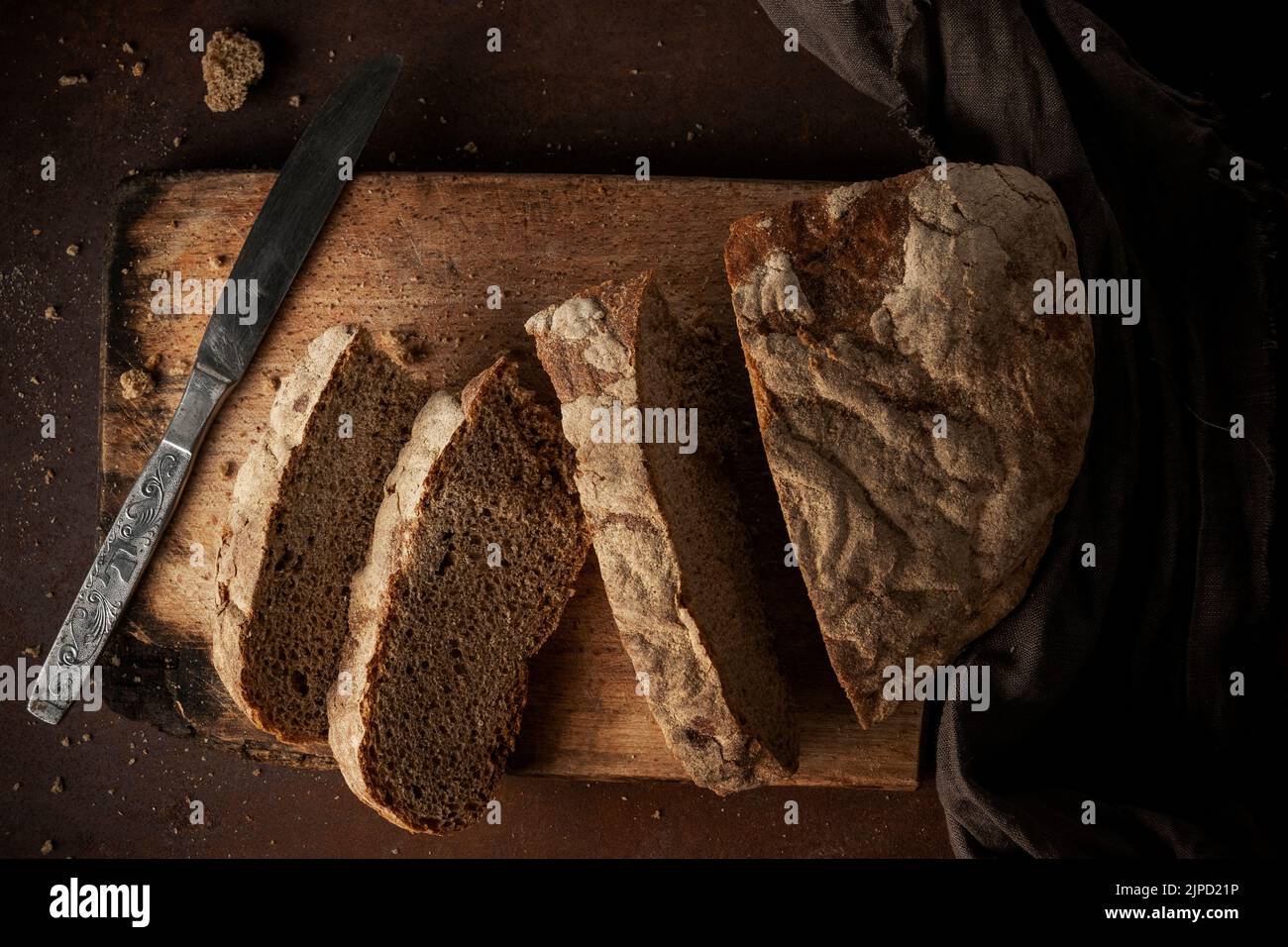 Low key food photography. Black rustic bread on dark background Stock ...