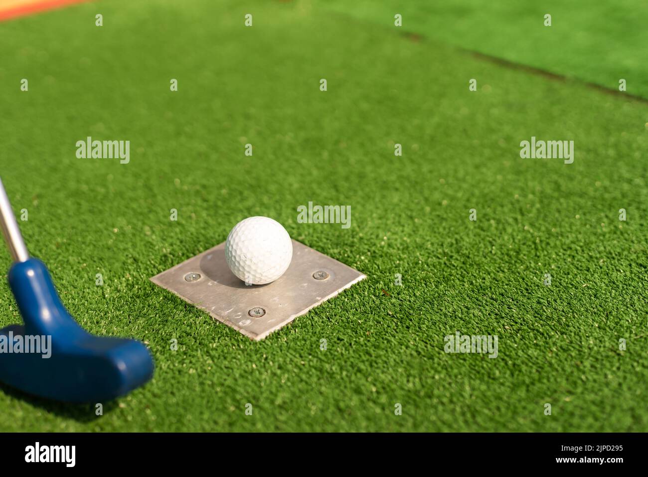 Close-up of miniature golf hole with bat and ball Stock Photo - Alamy