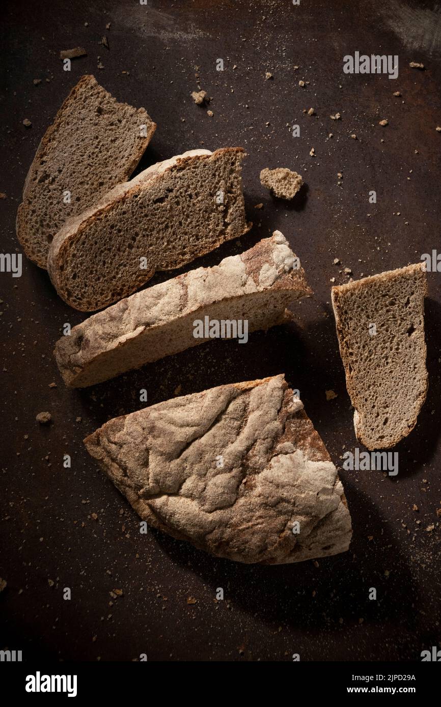 Low key food photography. Black rustic bread on dark background Stock ...