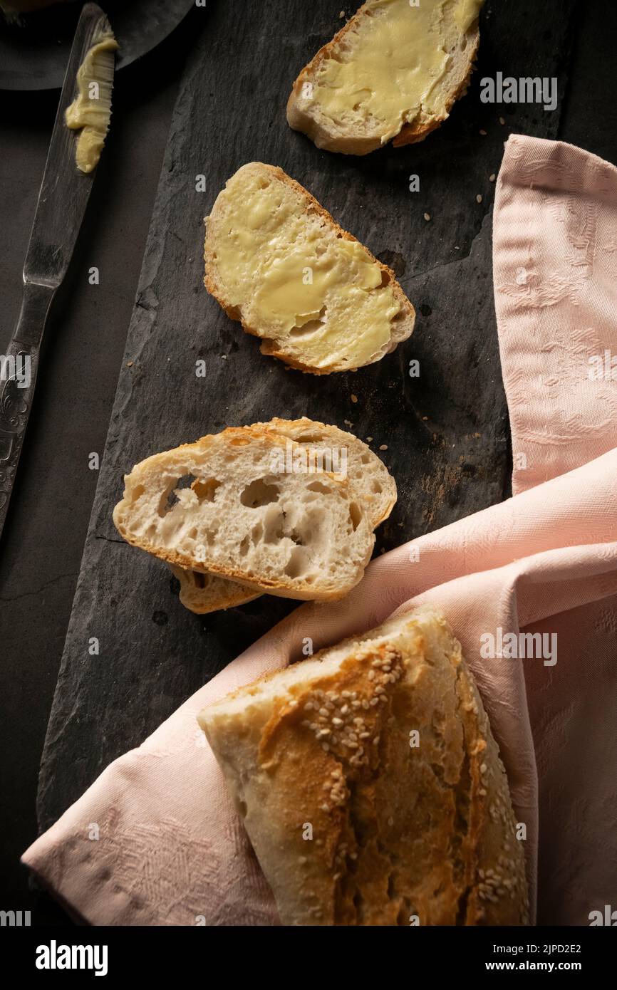 Low key food photography. Rustic bread with butter on dark background ...