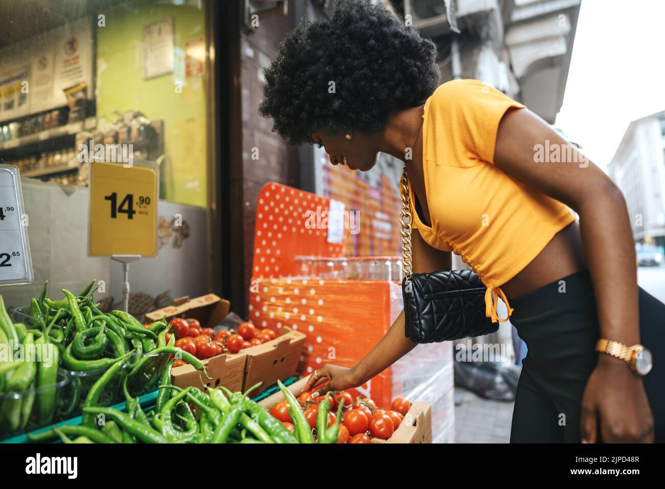 Young African American woman shopping at a local street market Stock ...
