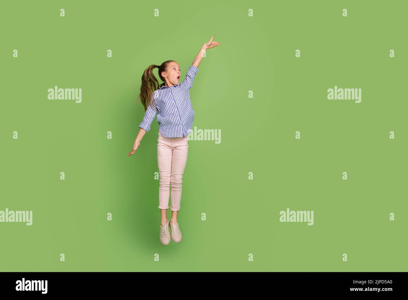 Full body photo of surprised kid girl jump measure large empty space ...