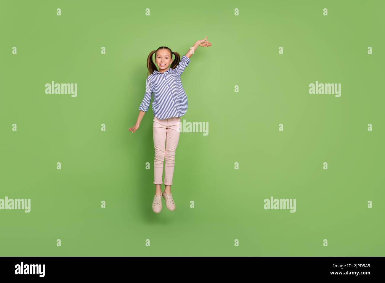 Photo of kid girl jump hold hand measure large empty space product ...