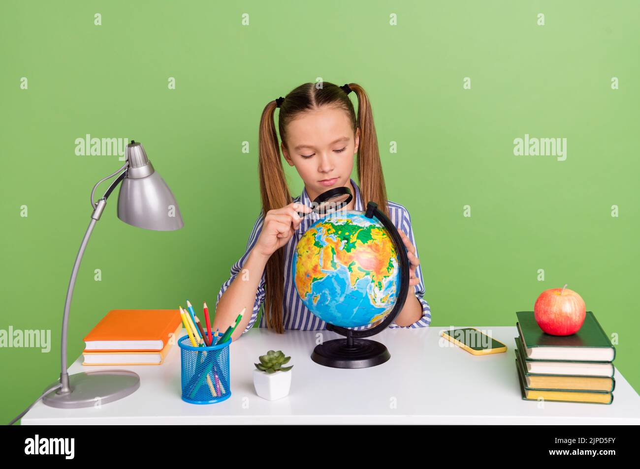 Photo of serious interested small schoolkid dressed striped uniform ...