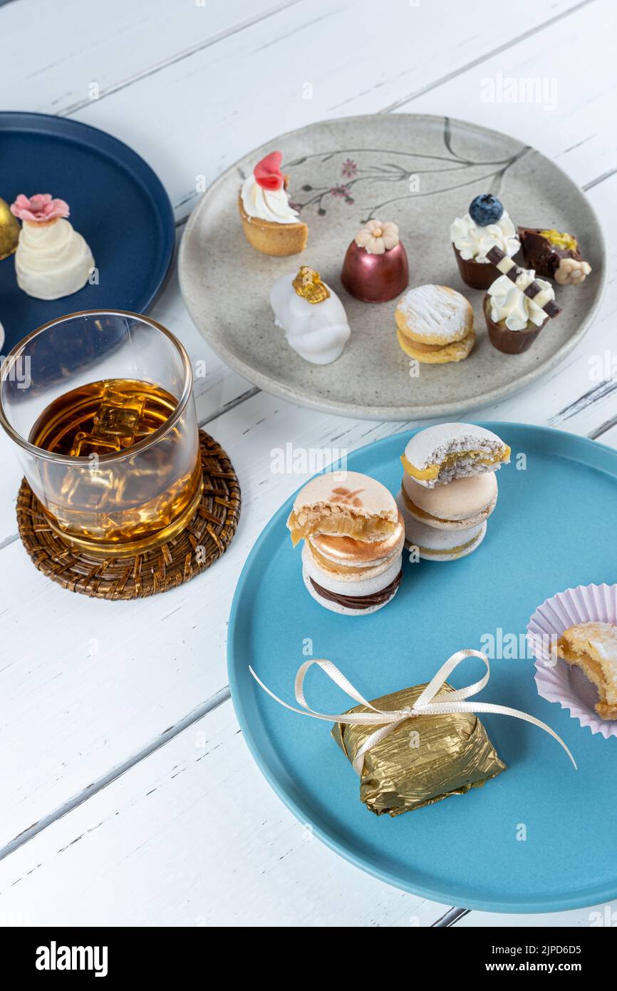Stacked macarons surrounded by an iced whiskey glass and fancy wedding ...